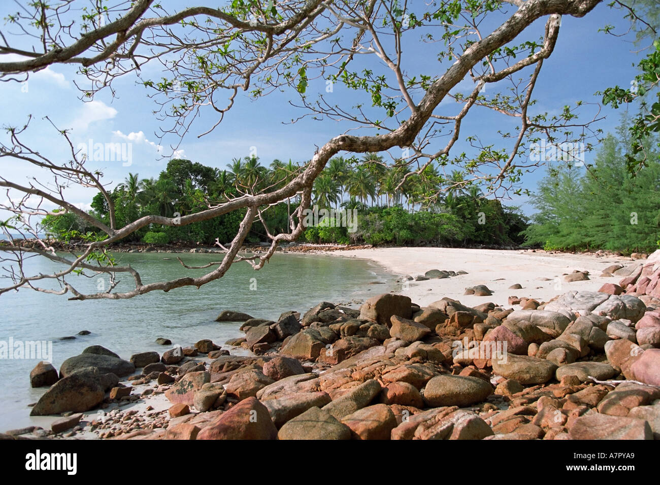 Secluded sandy beach with granite boulders at one side. Bintan island ...