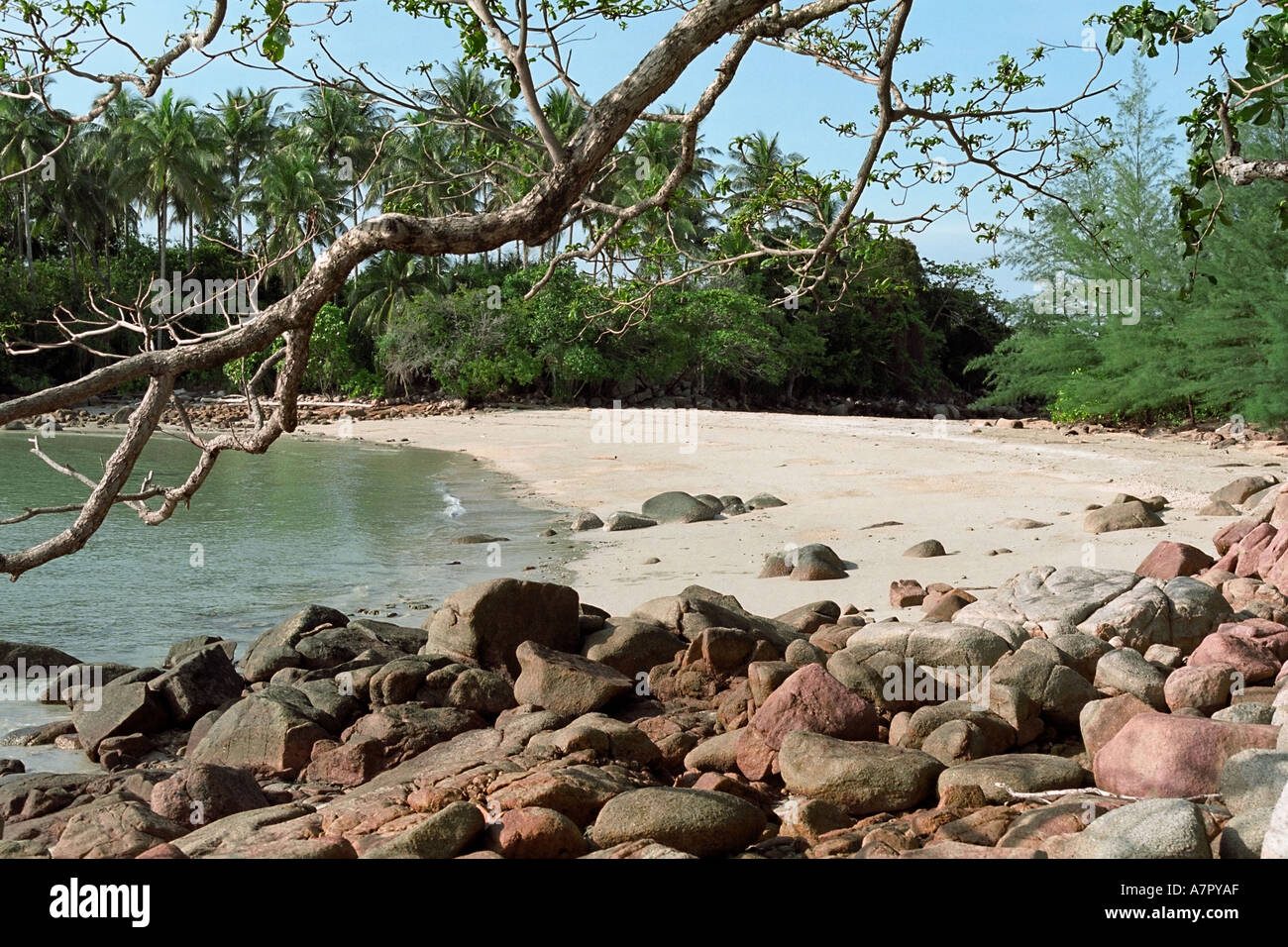 Secluded sandy beach with granite boulders at one side. Bintan island ...