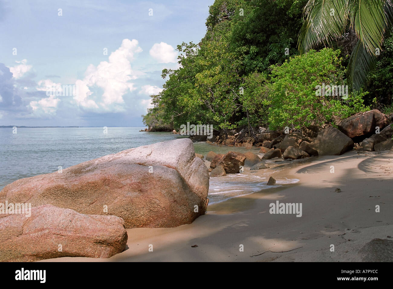 Secluded sandy beach with huge granite boulders. Bintan island ...