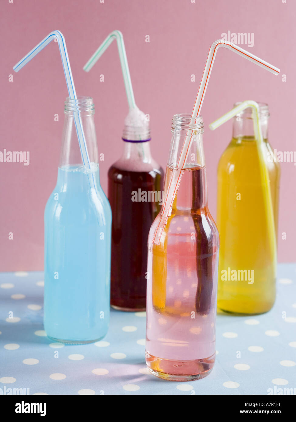 Four soda bottles with straws Stock Photo - Alamy