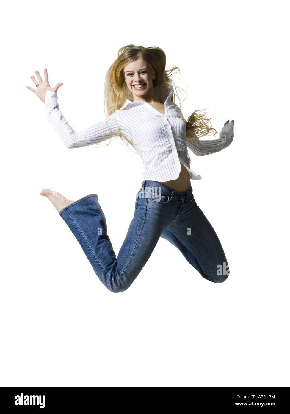 Woman leaping and smiling Stock Photo - Alamy