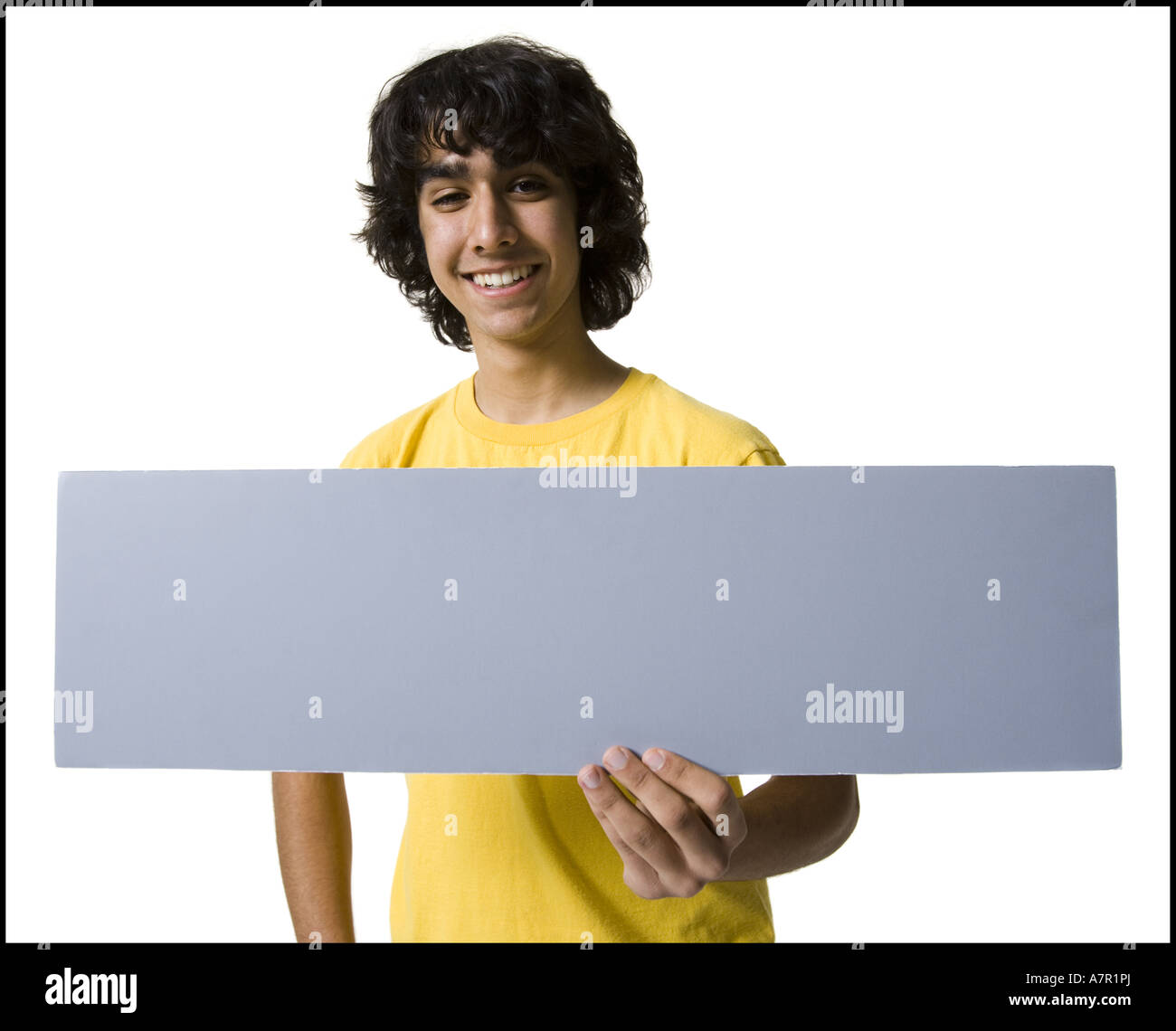 Teenage boy holding blank sign Stock Photo - Alamy