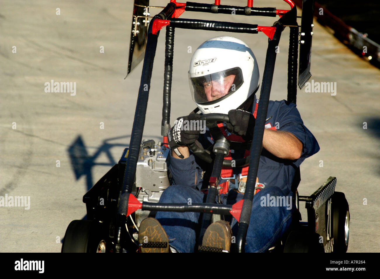 Kids and Dads racing small carts Stock Photo - Alamy
