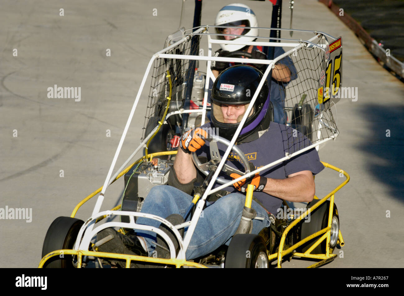 Kids and Dads racing small carts Stock Photo - Alamy