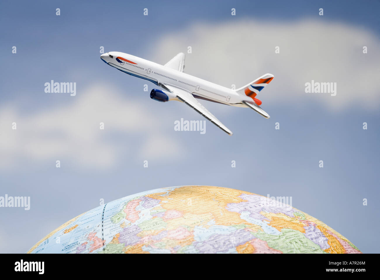 Airplane flying over globe with blue sky Stock Photo - Alamy