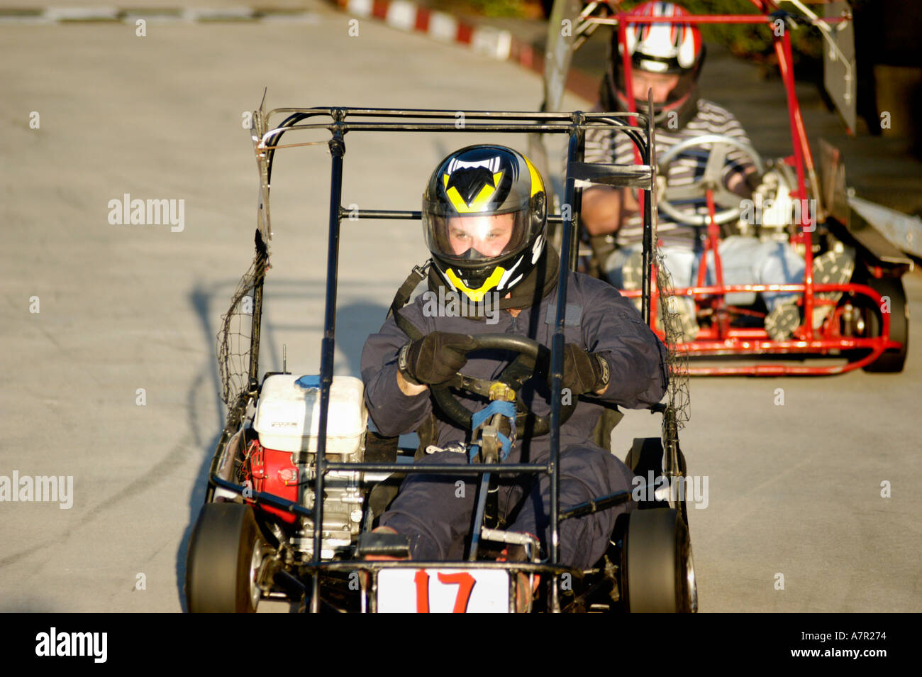 Kids and Dads racing small carts Stock Photo - Alamy