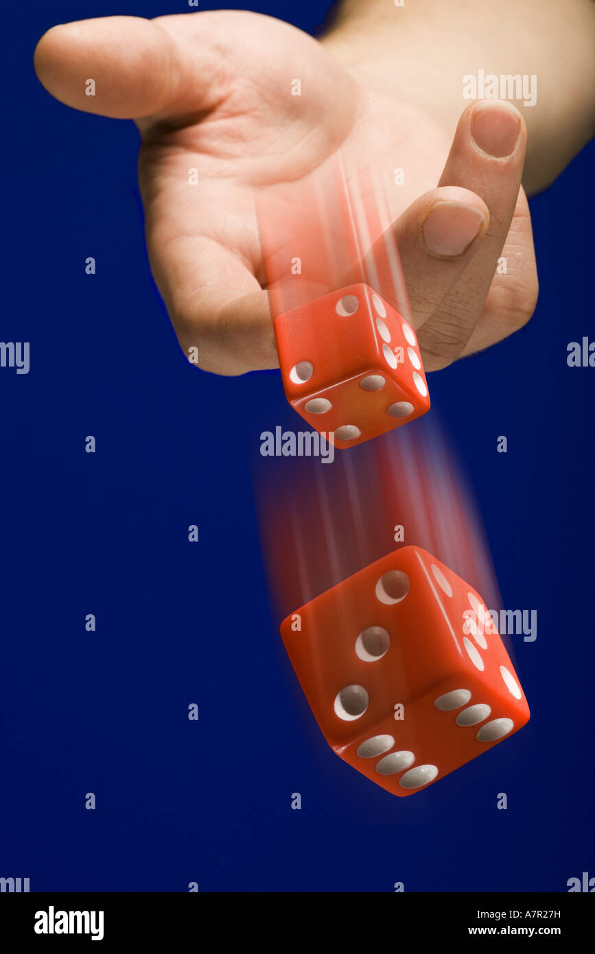 Man rolling dice with motion blur Stock Photo - Alamy
