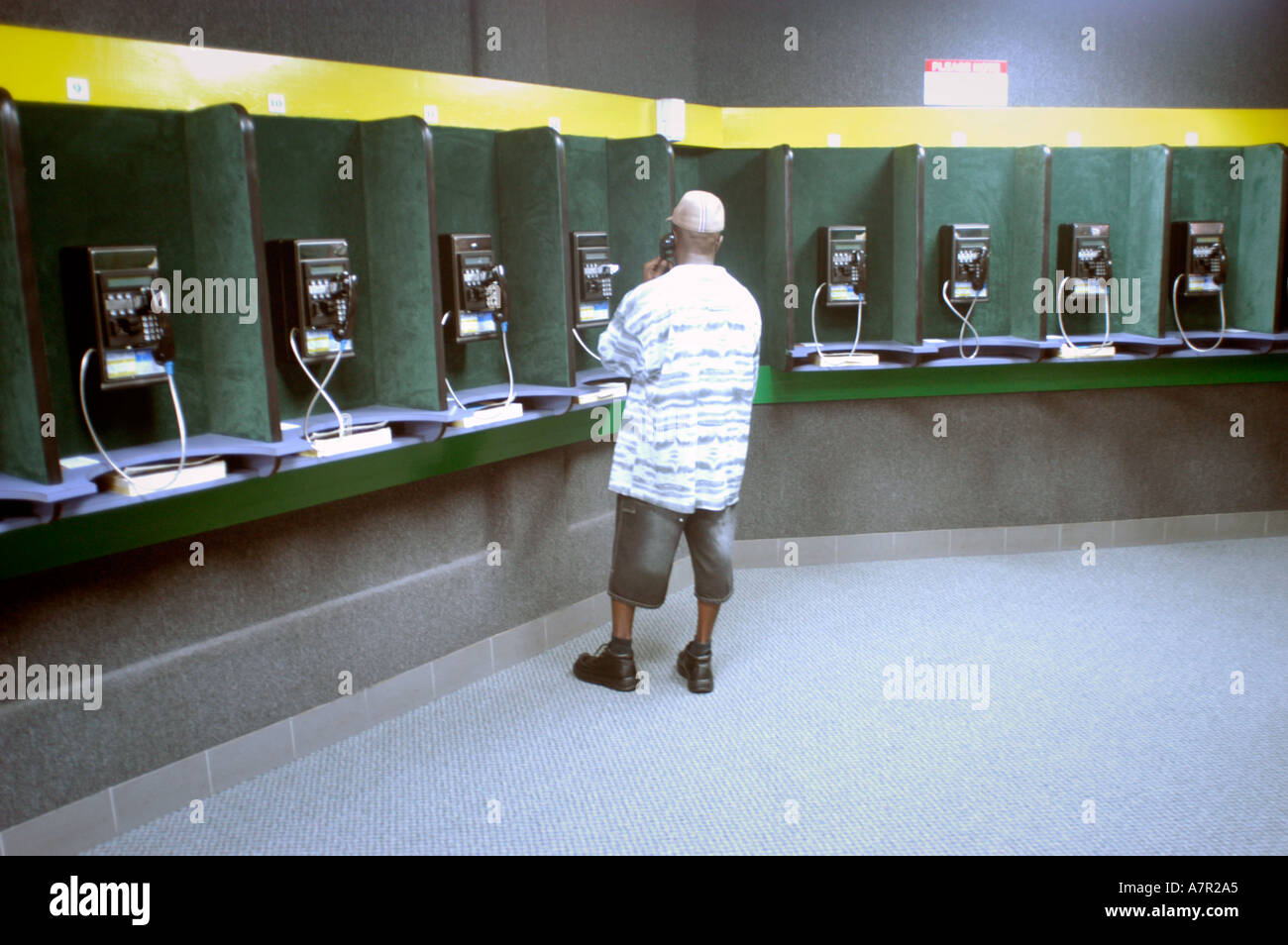 Male Man at bank of older out of date push button public phones making ...