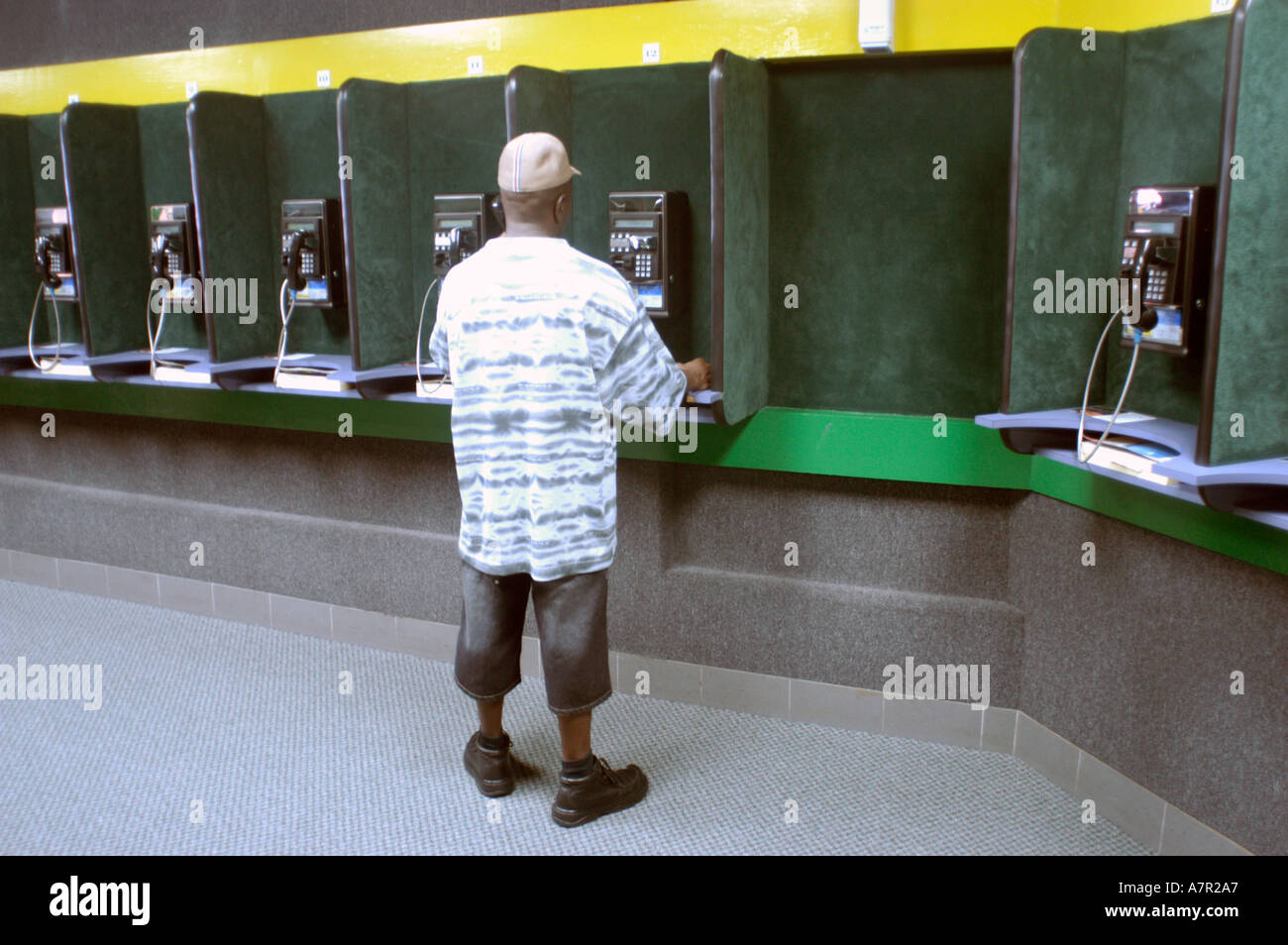 Male Man at bank of older out of date push button public phones making ...