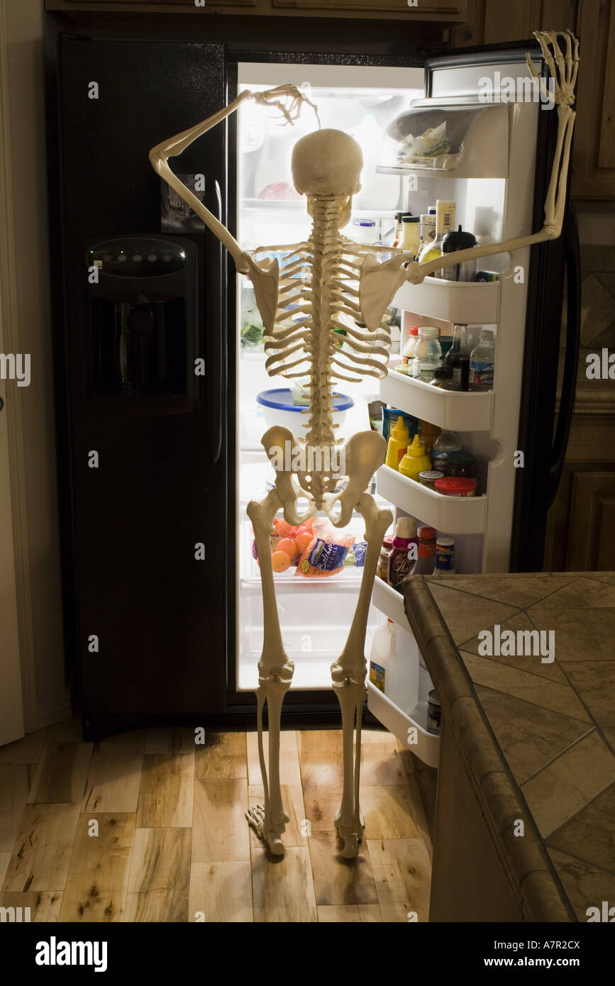 Skeleton looking inside refrigerator Stock Photo - Alamy