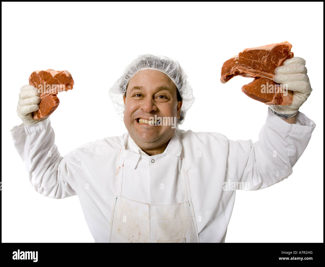 Butcher with steaks smiling Stock Photo - Alamy