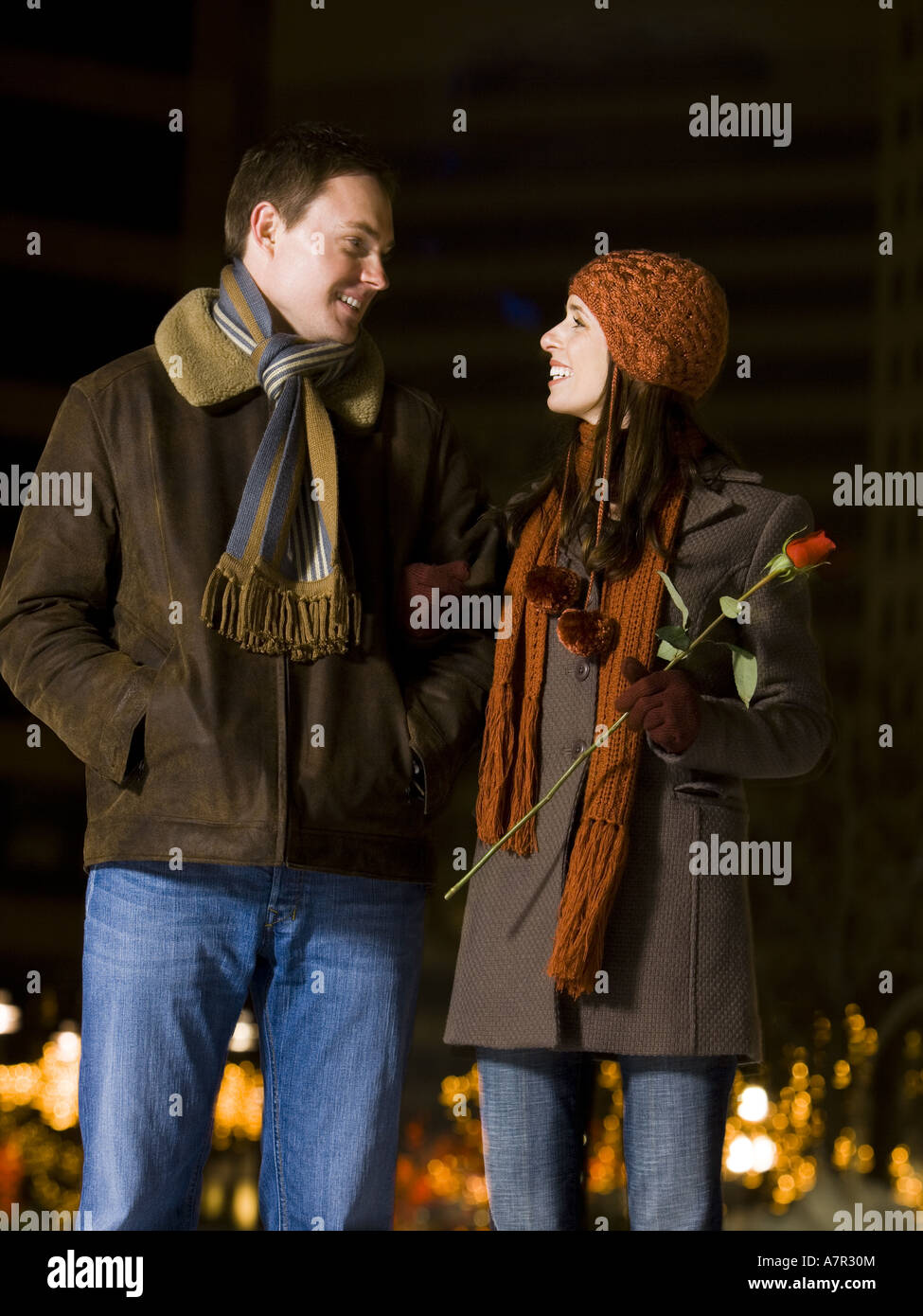 Man and woman with red rose outdoors in winter Stock Photo - Alamy