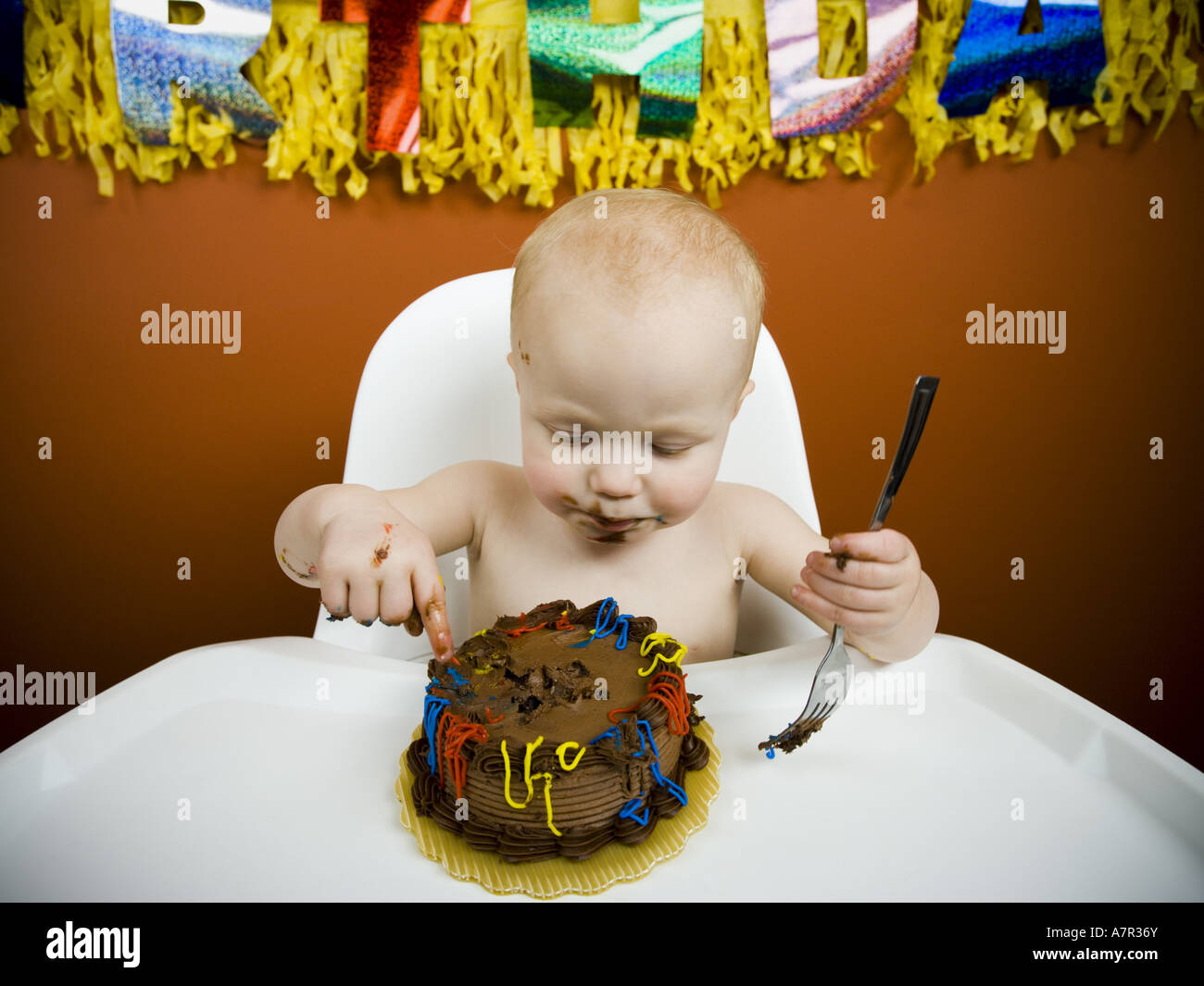 Baby eating birthday cake Stock Photo - Alamy