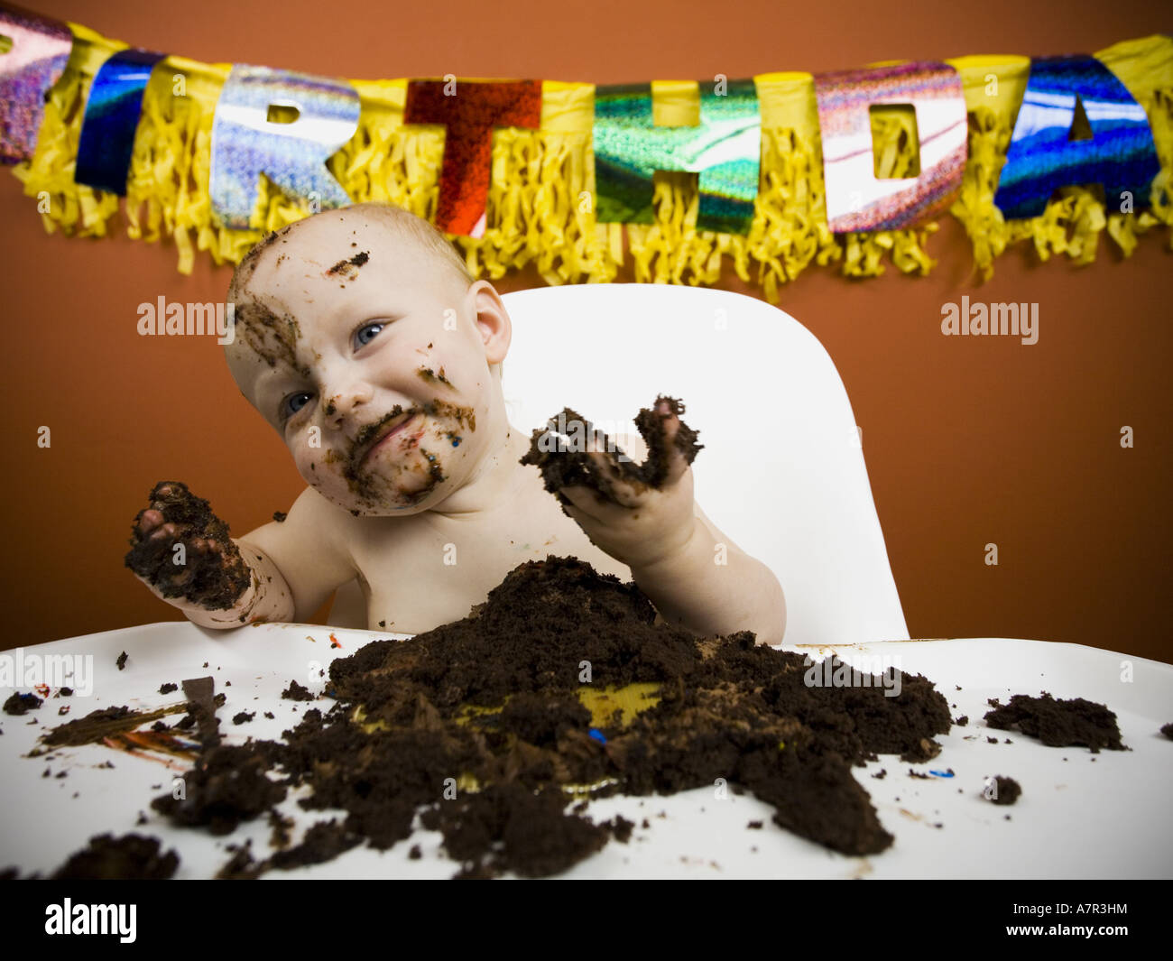 Baby eating birthday cake Stock Photo - Alamy