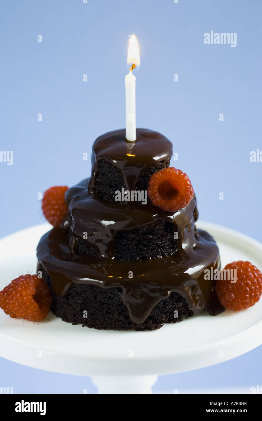 Chocolate birthday cake with raspberries and candle Stock Photo - Alamy