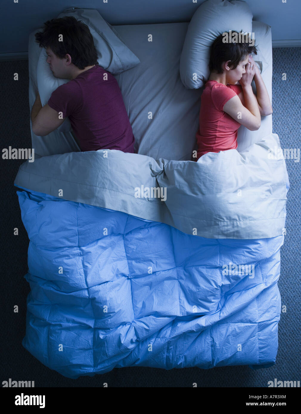 Man and woman sleeping in bed with backs to each other Stock Photo - Alamy