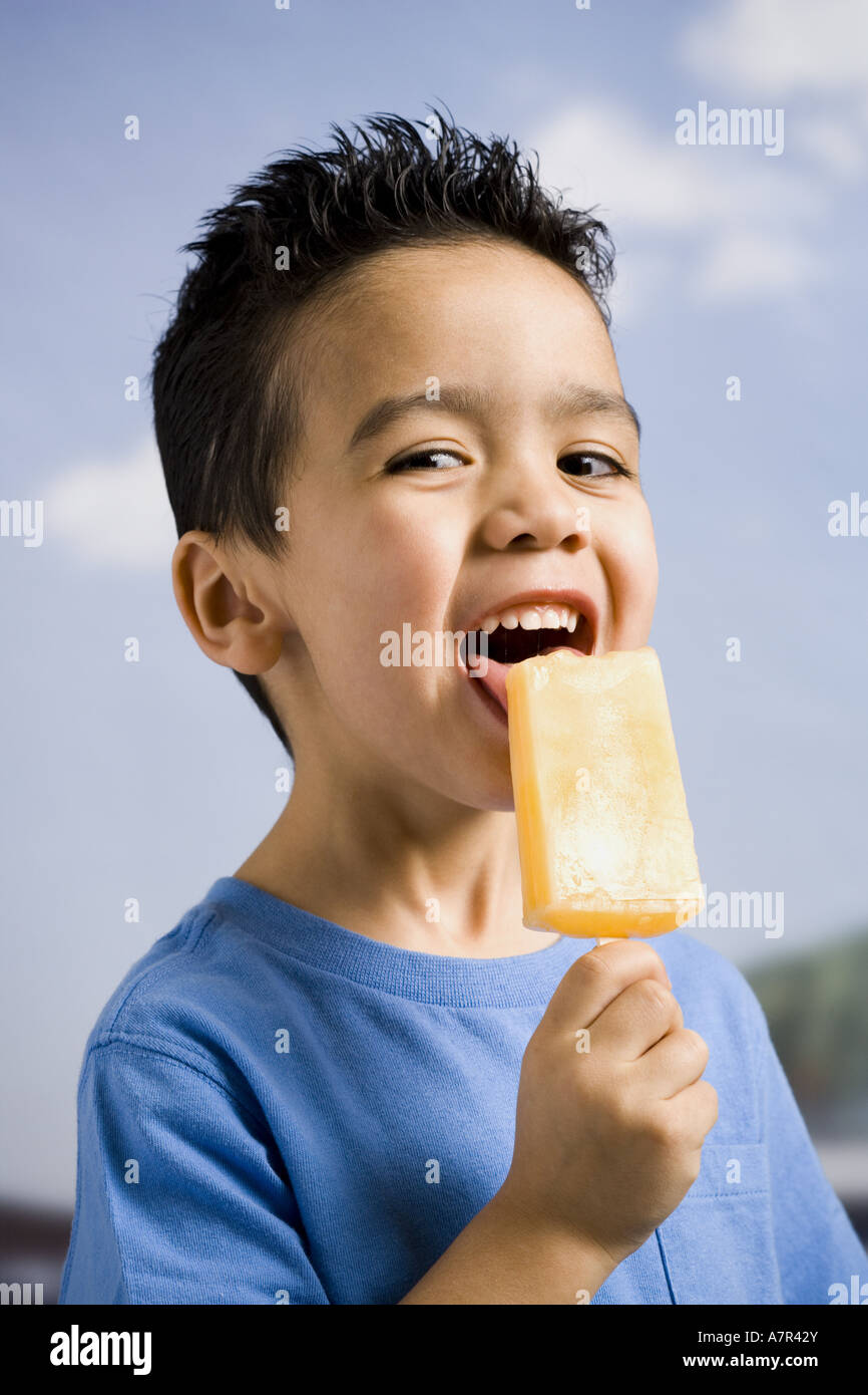 Boy eating Popsicle smiling Stock Photo - Alamy