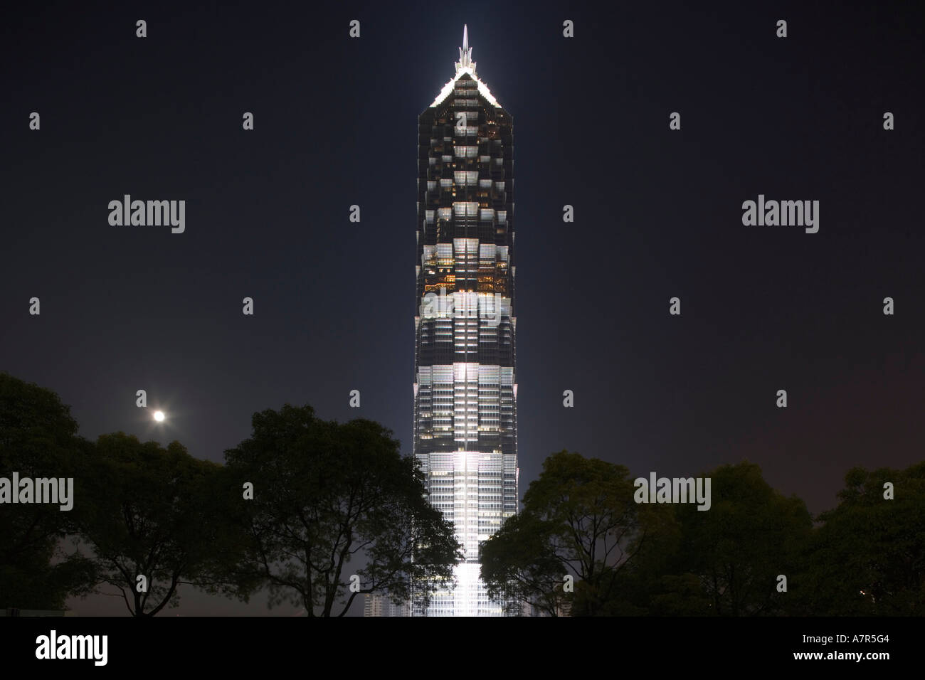 Asia China Shanghai Full moon rises behind illuminated steel and glass ...