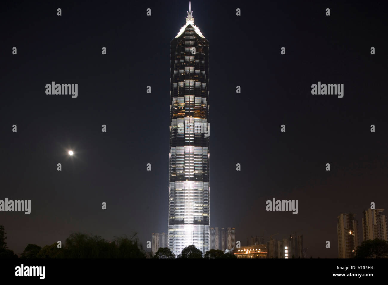 Asia China Shanghai Full moon rises behind illuminated steel and glass ...