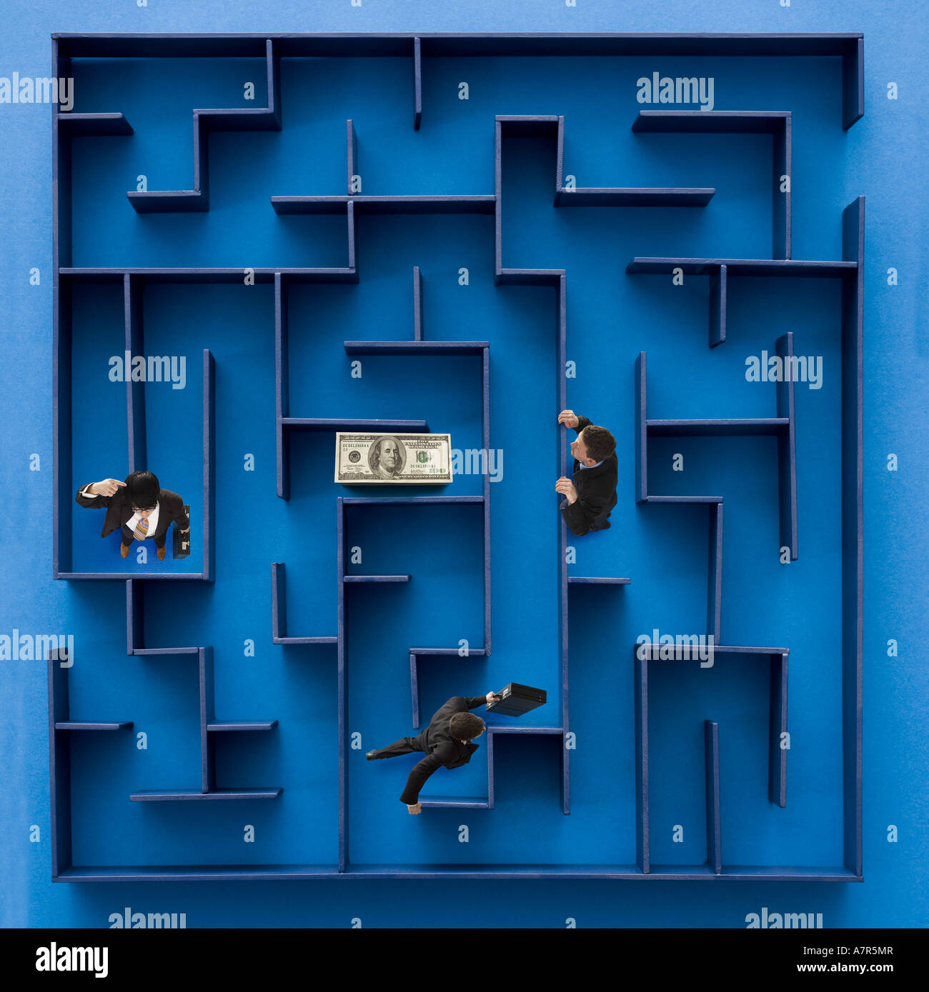 Three businessmen in maze with American money Stock Photo - Alamy