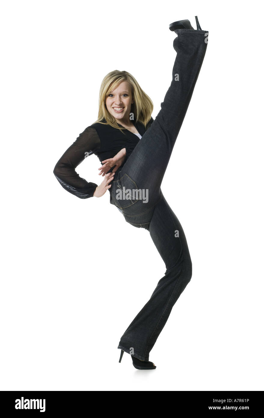 Woman kicking leg up and smiling Stock Photo - Alamy