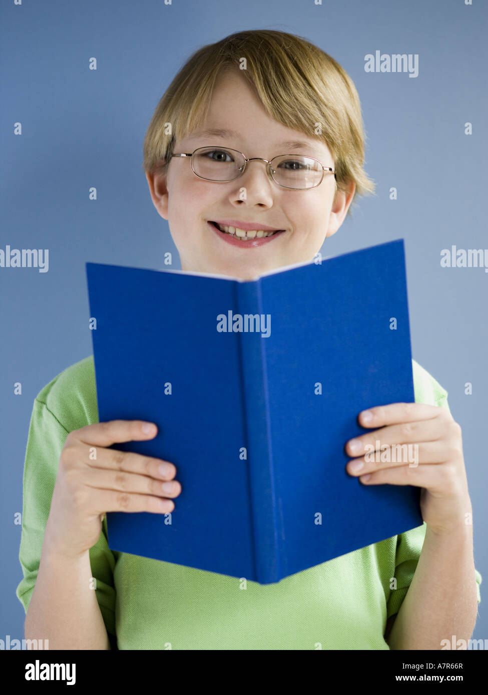 Boy reading book and smiling Stock Photo - Alamy