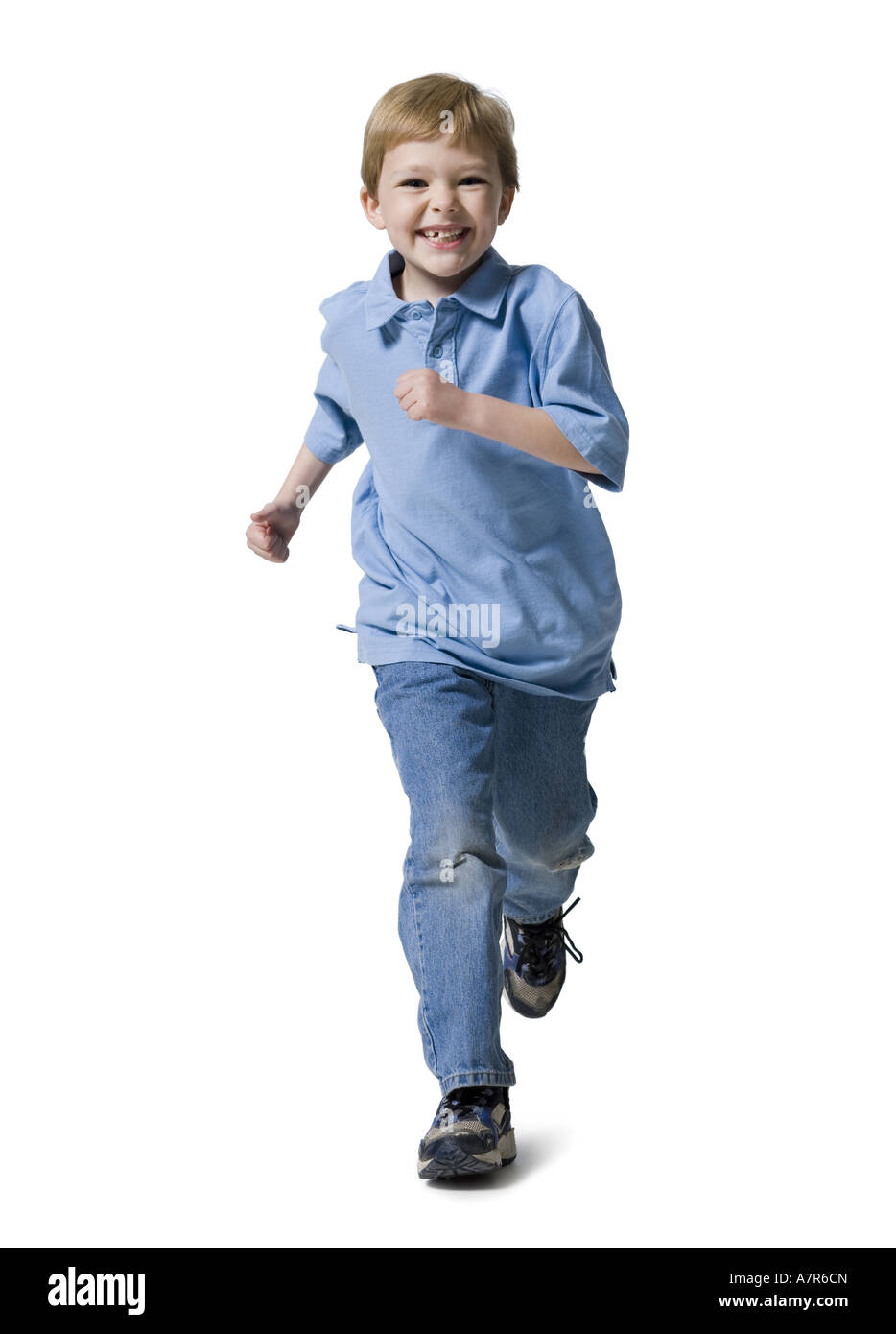 Boy running and smiling Stock Photo - Alamy