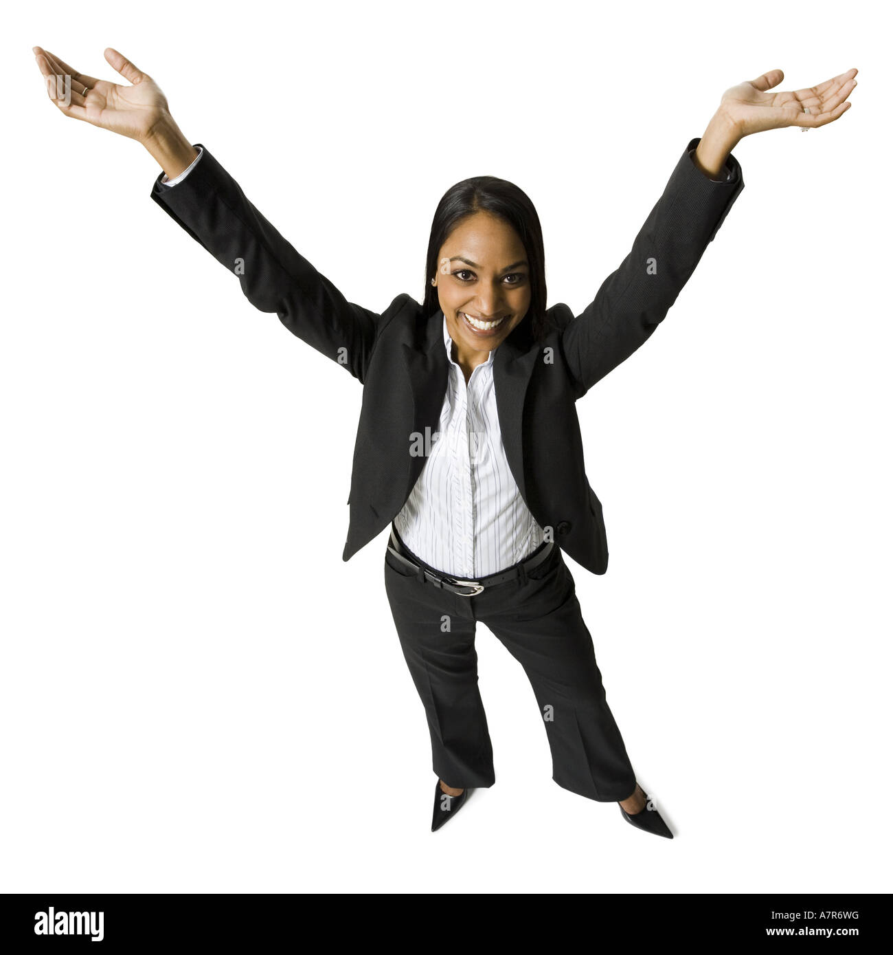Businesswoman standing with arms up Stock Photo - Alamy