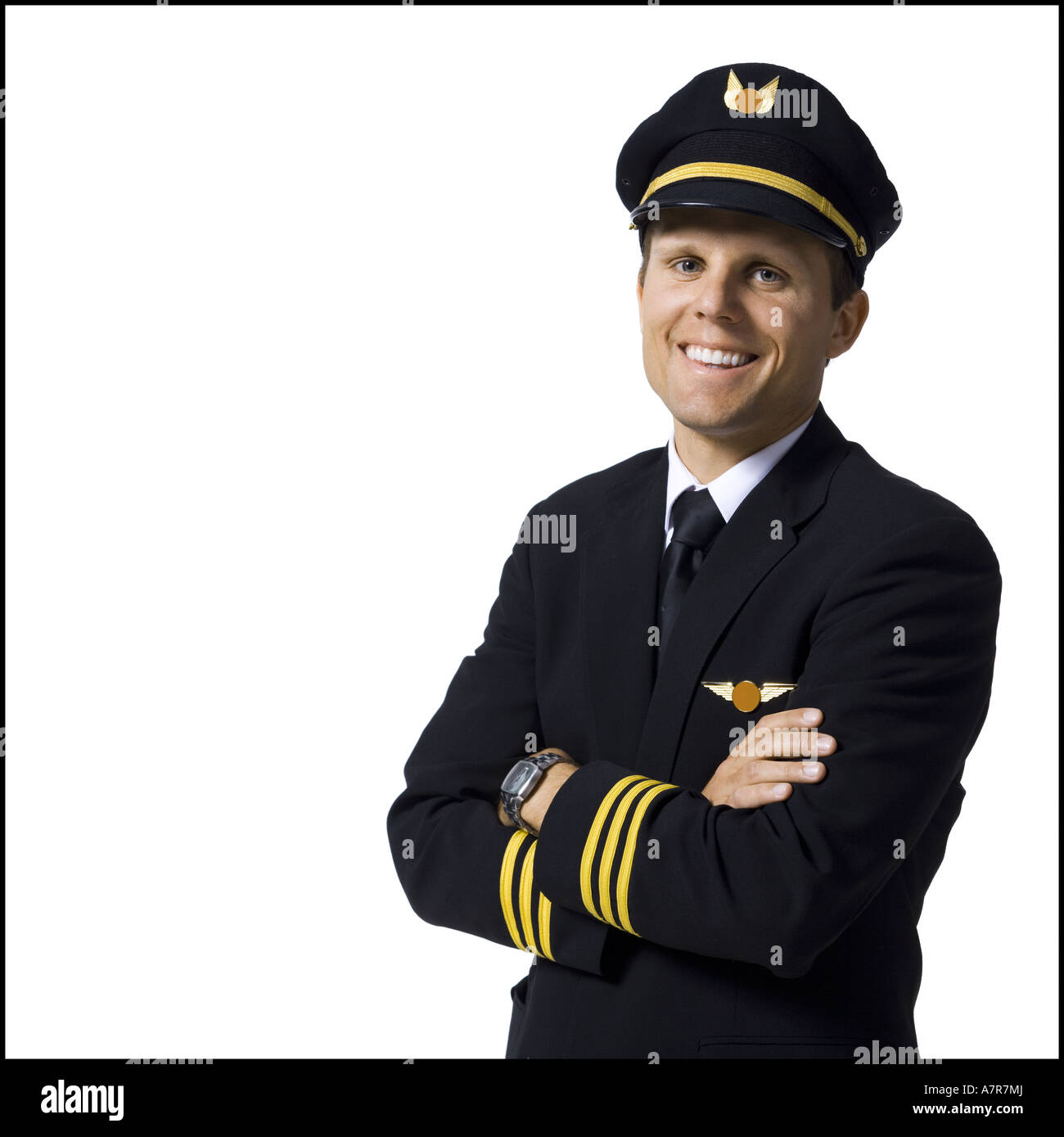 Pilot standing with arms crossed smiling Stock Photo - Alamy