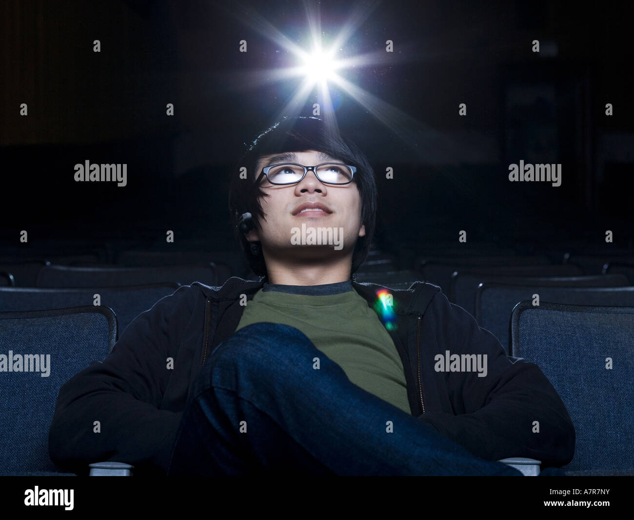Man with eyeglasses watching film at movie theater Stock Photo - Alamy