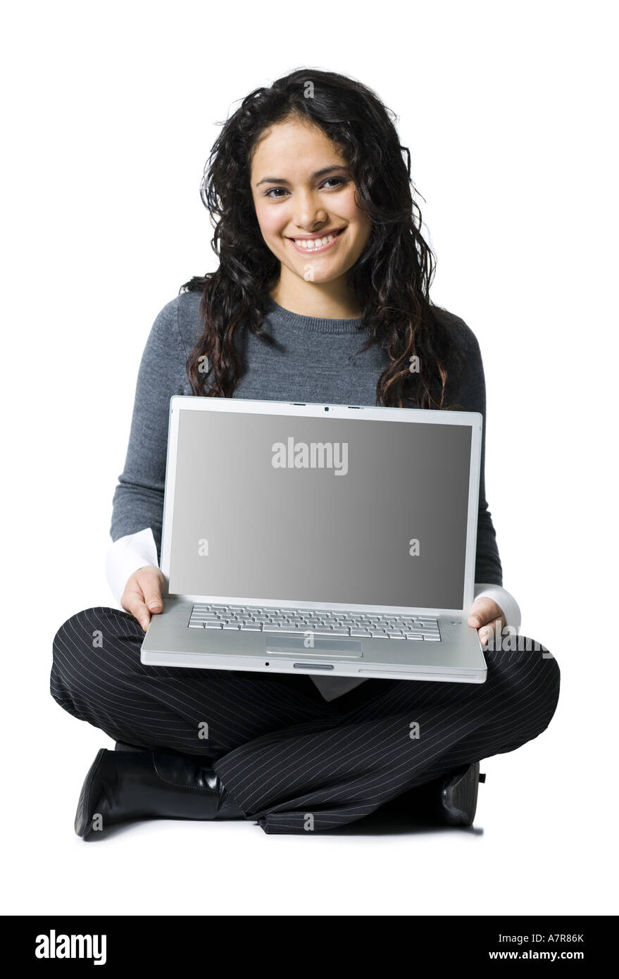 Woman sitting cross legged with laptop smiling Stock Photo - Alamy
