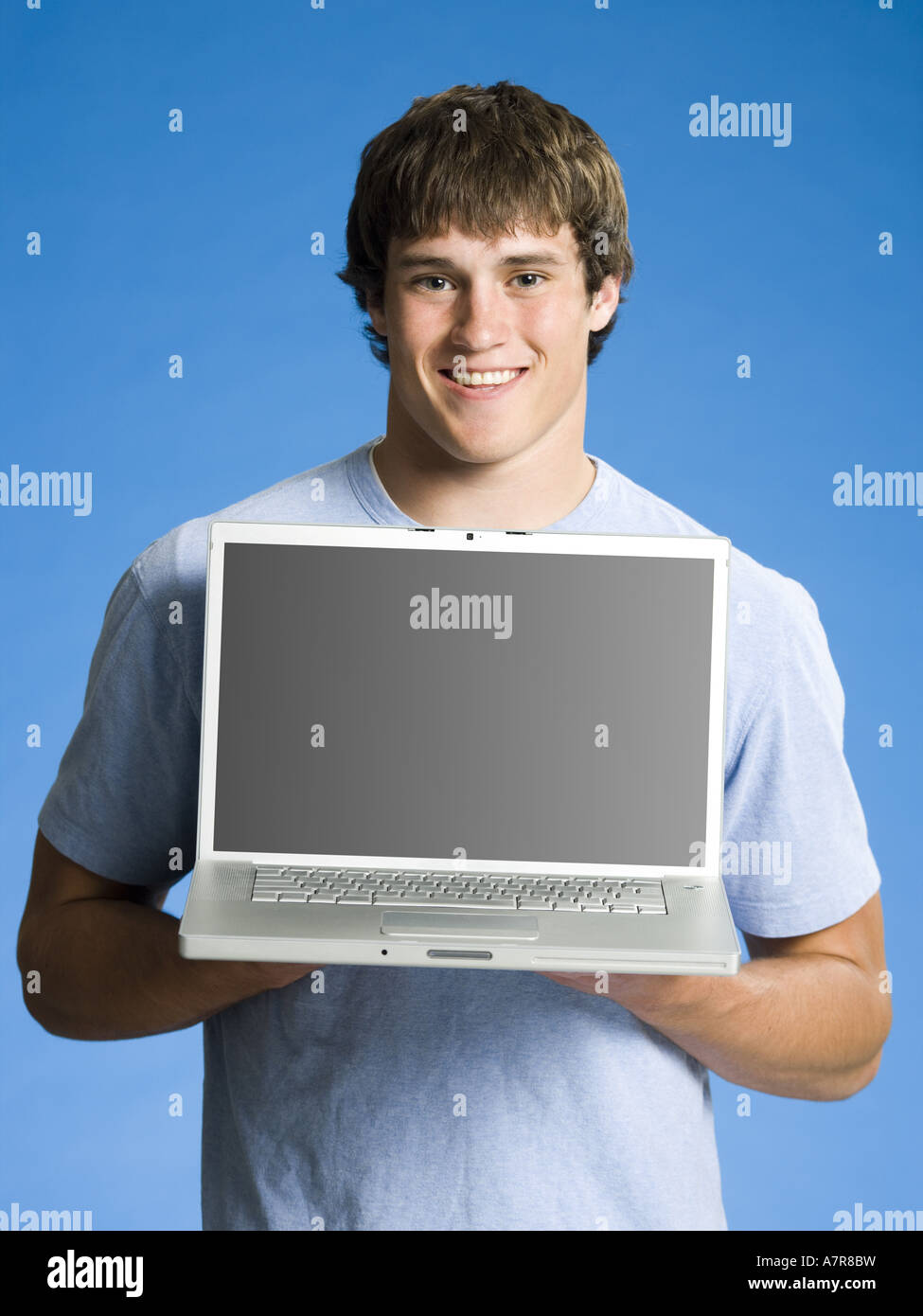 Boy with laptop smiling Stock Photo - Alamy