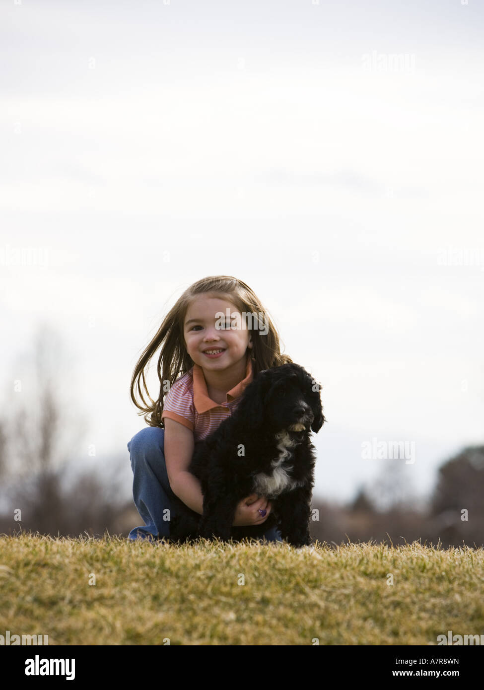 Girl with puppy outdoors Stock Photo - Alamy