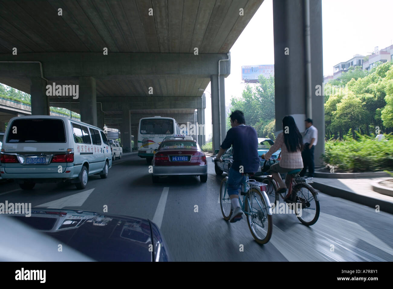 Asia China Shanghai View through taxi window driving past bicyclists in ...