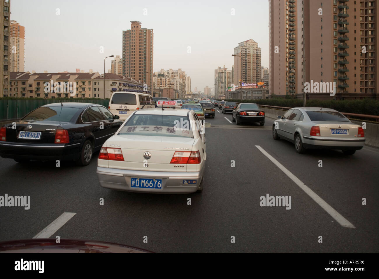 Asia China Shanghai View through window of taxi driving through evening ...