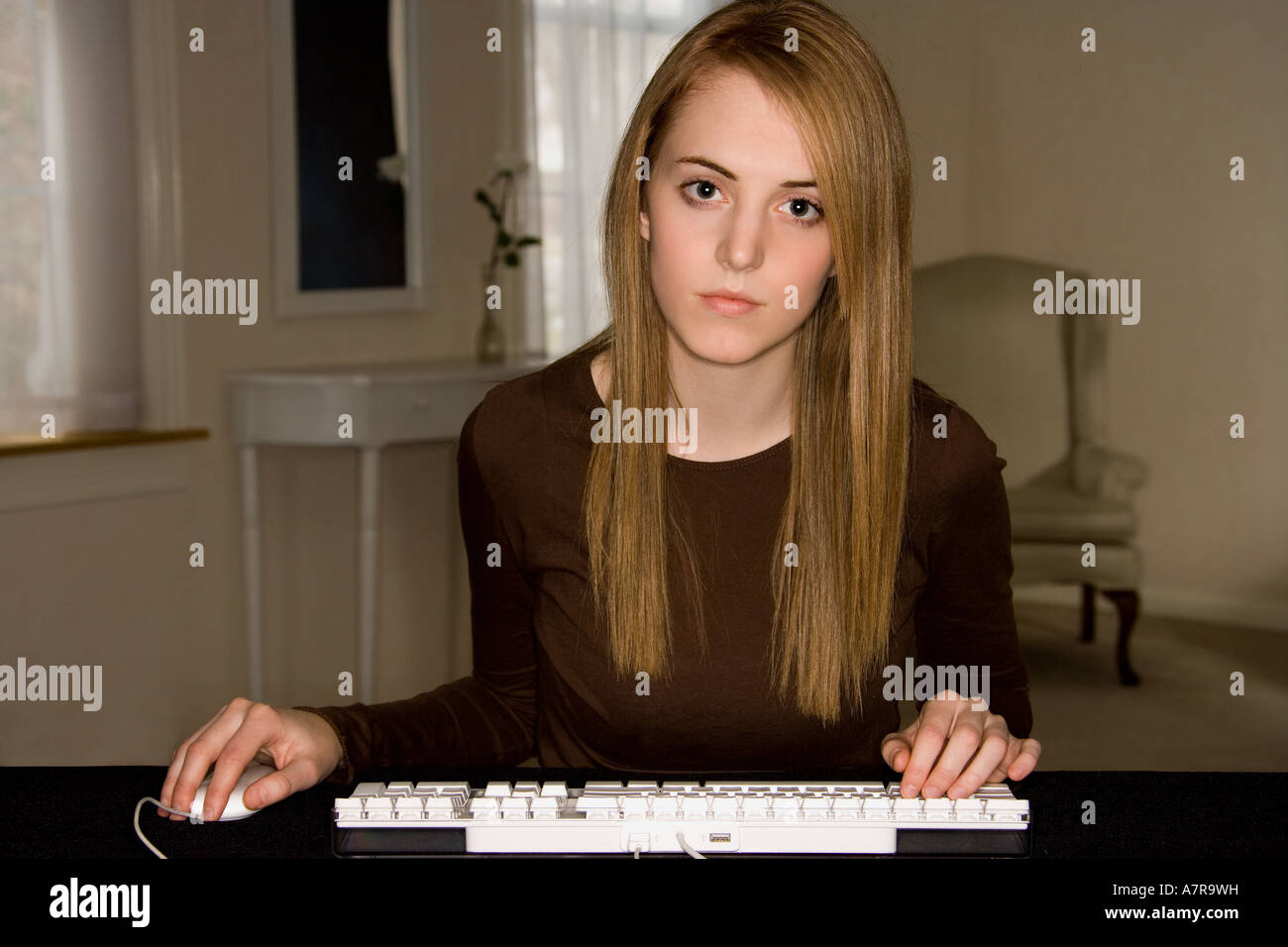 Girl at computer in home Stock Photo - Alamy