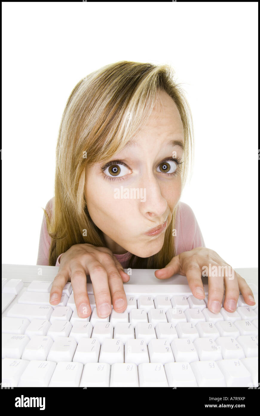 Woman at keyboard looking perplexed Stock Photo - Alamy