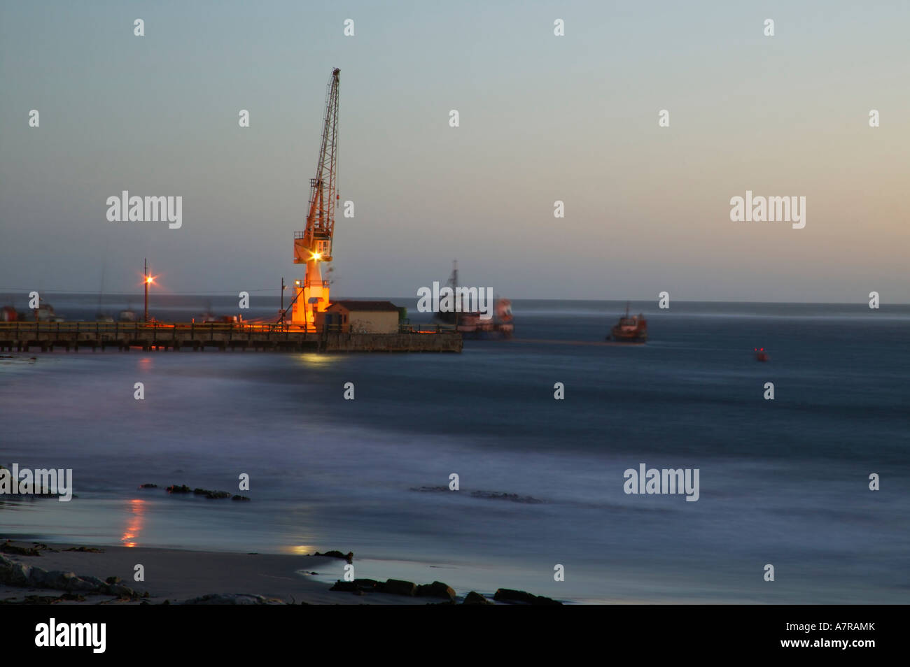 A crane and diamond trawlers in Port Nolloth harbour at dusk Port ...