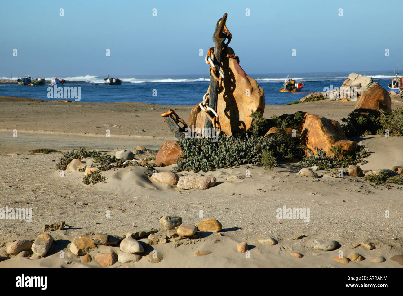 A ship anchor propped up against a rock against the backdrop of diamond ...