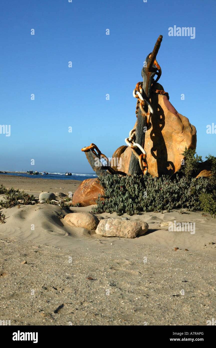 A ship anchor propped up against a rock against the backdrop of diamond ...