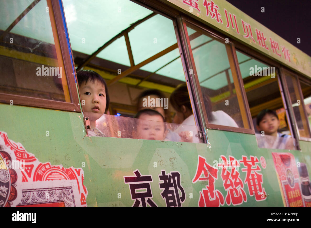 Asia China Shanghai Young Chinese children peer out window while ...