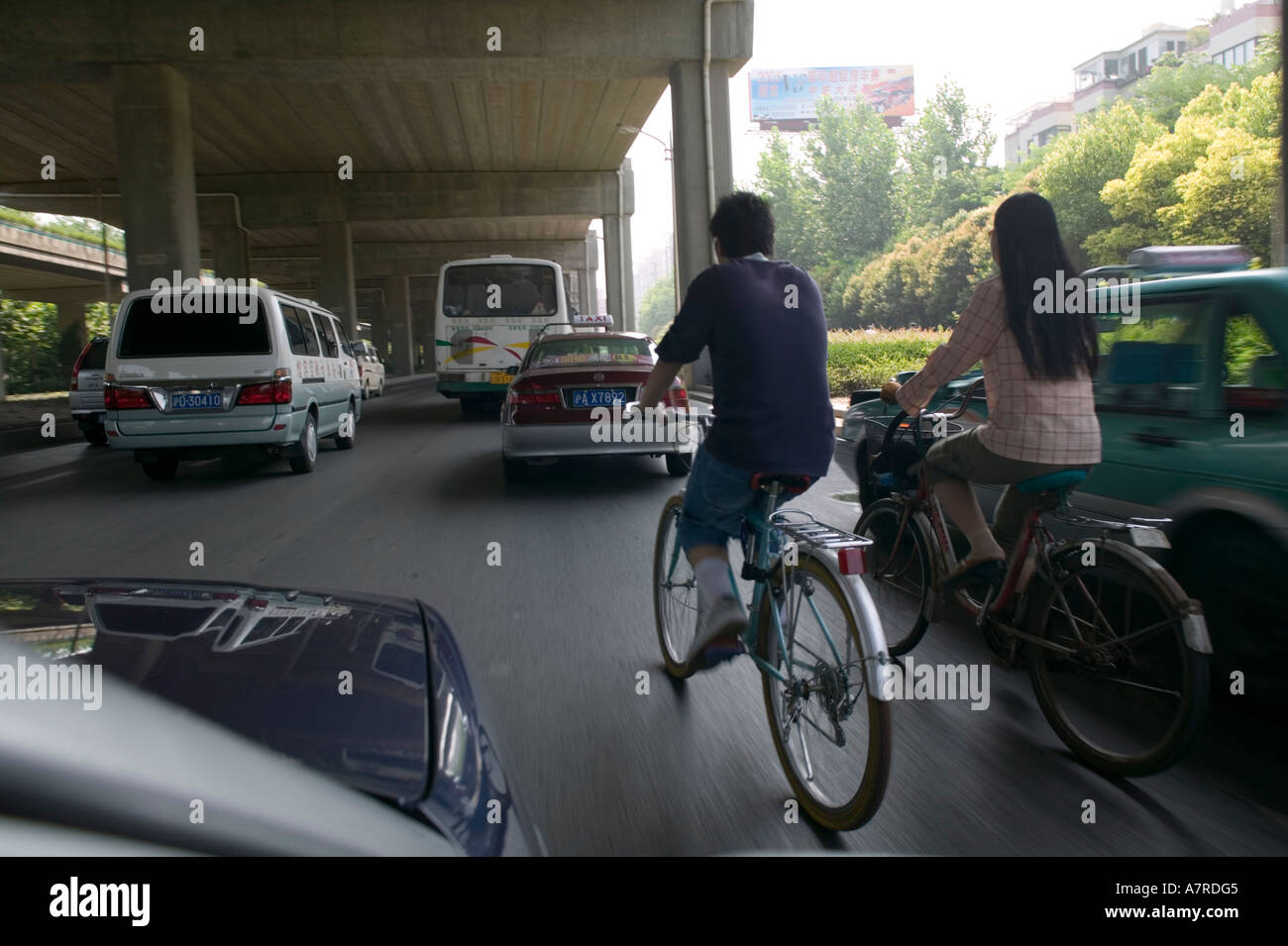 Asia China Shanghai View through taxi window driving past bicyclists in ...