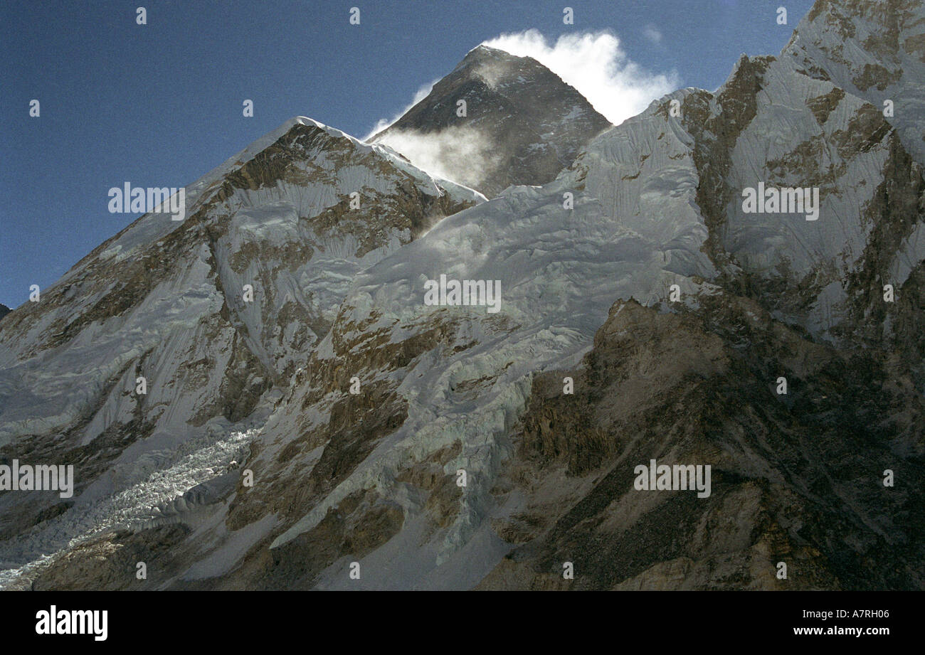 the summit of mount everest with its own weather clouds visible is seen ...
