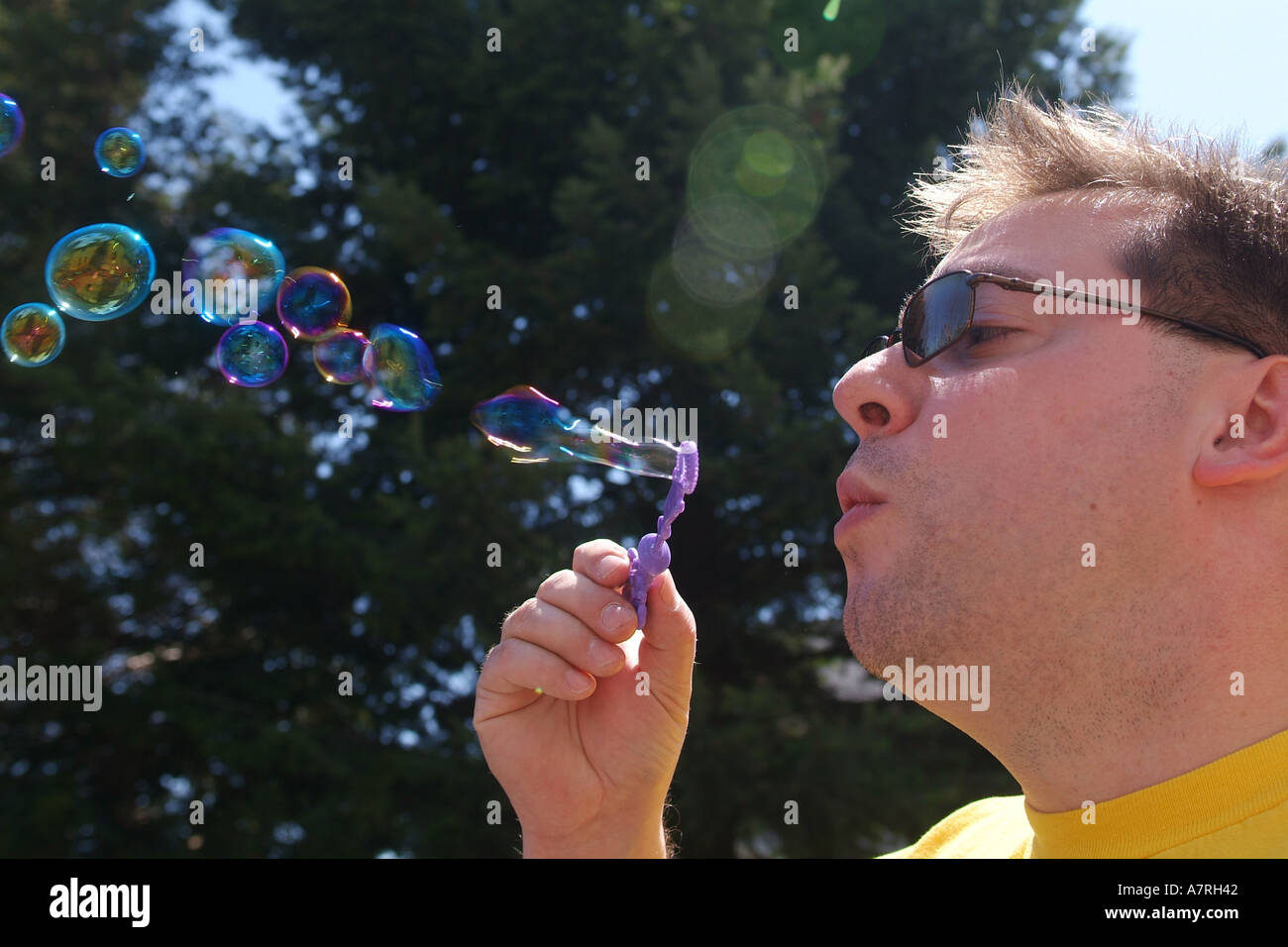 Man blowing bubbles Stock Photo - Alamy