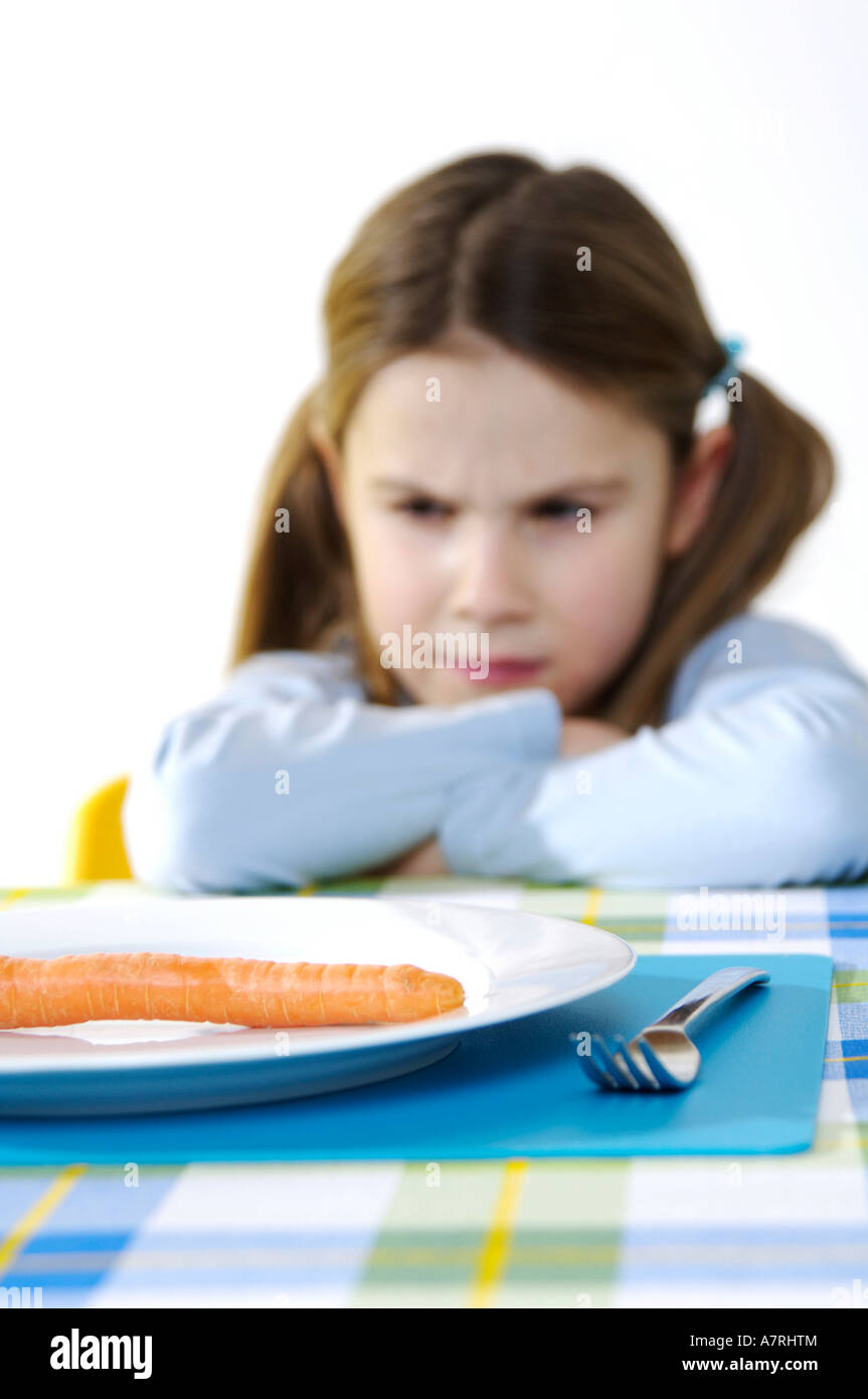 Girl sitting at table Stock Photo - Alamy
