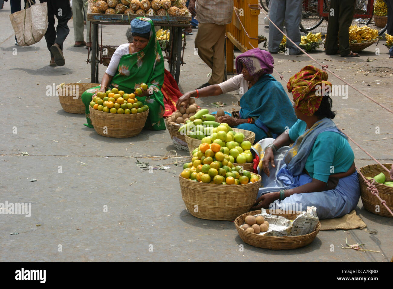Women on a market in Old Delhi sheltering from the heat under a piece ...