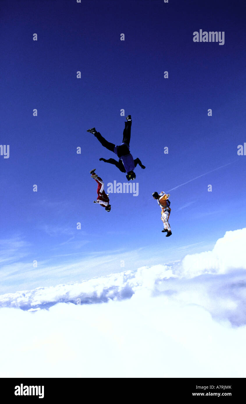 three people skydiving on skateboard Stock Photo - Alamy