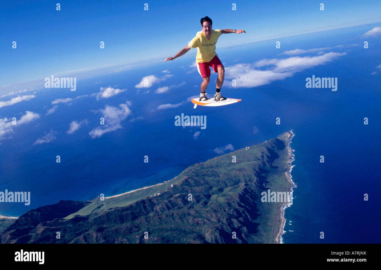 Man flying with surfboard Stock Photo - Alamy