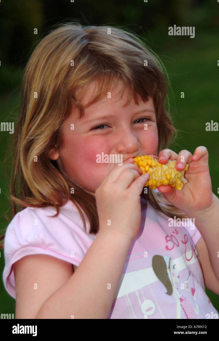 Young Female Child Eating Corn on the Cob Stock Photo - Alamy