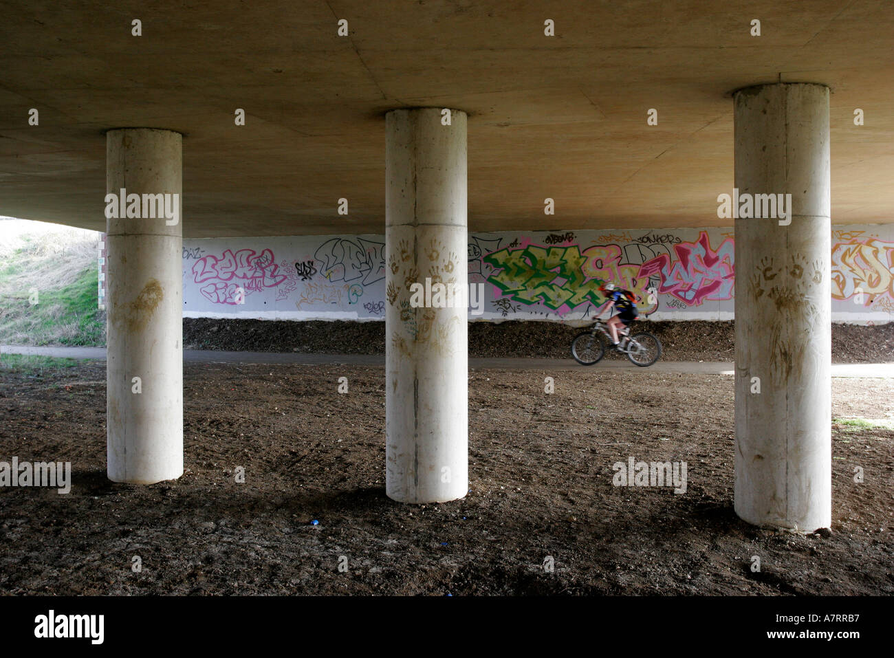 Subway under the road with graffiti and muddy hand prints on supporting ...
